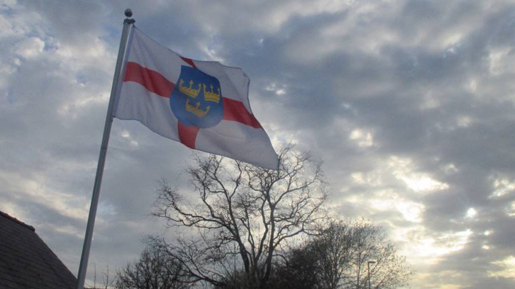 The flag of East Anglia in flight. | British County Flags